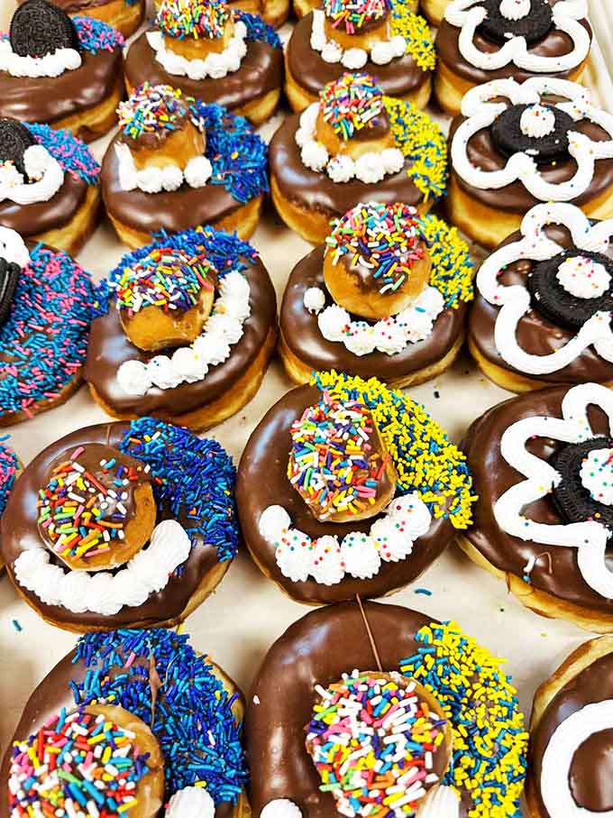 Chocolate-dipped delights adorned with whimsical decorations prove that donuts, like people, wear their personalities on their outsides.