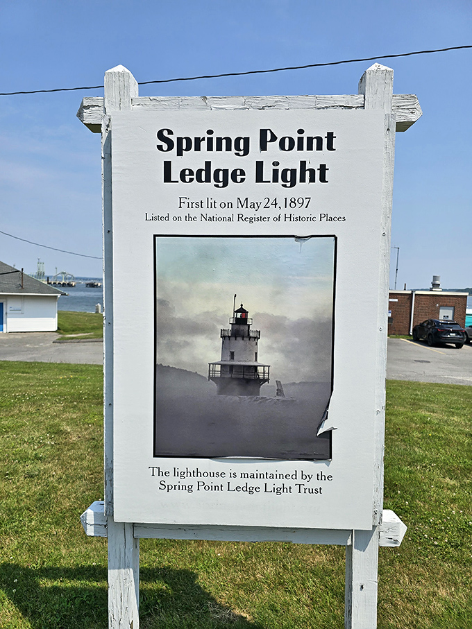 "First lit on May 24, 1897" - this informational sign reveals the lighthouse's long history of guiding mariners safely through Casco Bay.
