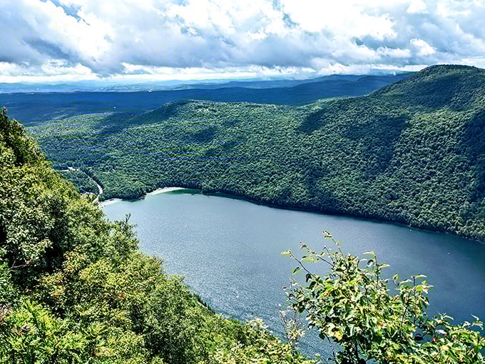 The lake's distinctive profile reveals itself from above, a sapphire slash through Vermont's endless green tapestry.