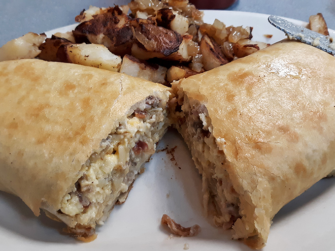 Peek inside this breakfast burrito and discover a world of flavors carefully tucked into a portable morning masterpiece.