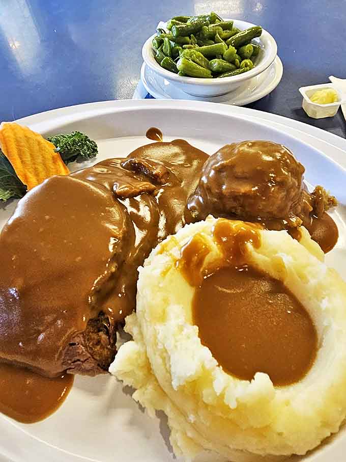 Jim's Famous Homemade Meatloaf arrives smothered in rich gravy with a cloud of mashed potatoes – comfort food that could make a grown adult weep with joy.