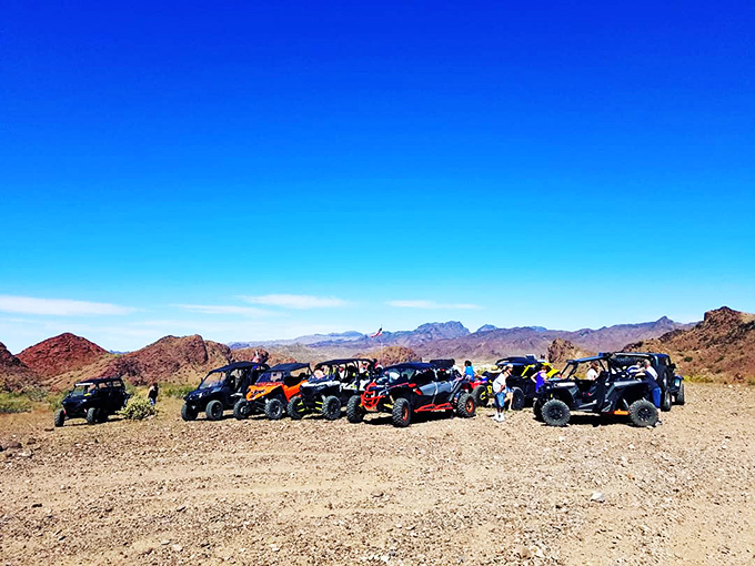 Off-road enthusiasts gather at trail's end, dusty and grinning after conquering Buckskin's challenging backcountry routes.