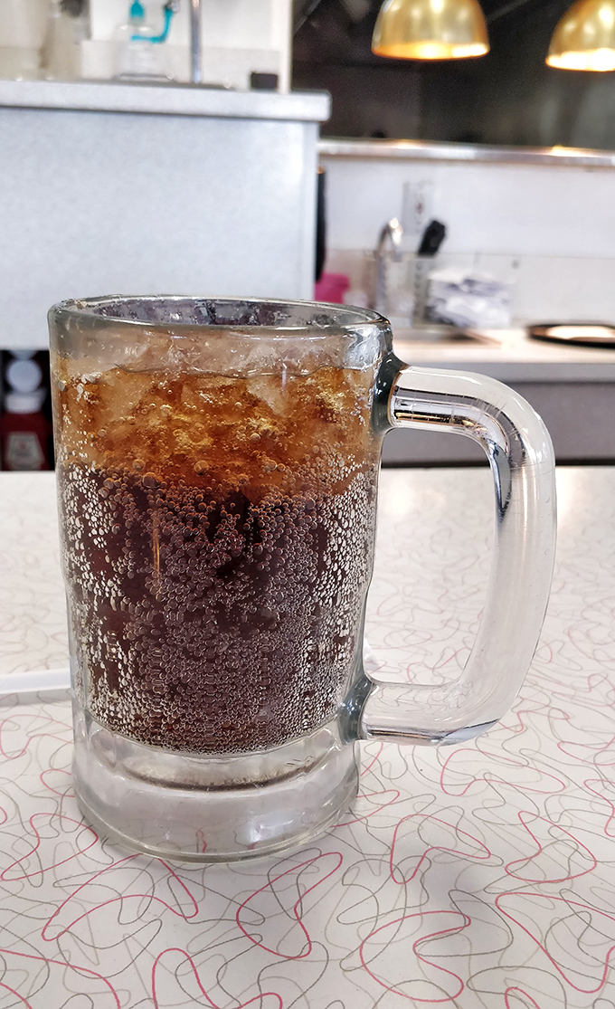 Bubbles dance in this mug of handcrafted root beer, creating a symphony of sweetness that's been perfected over decades.