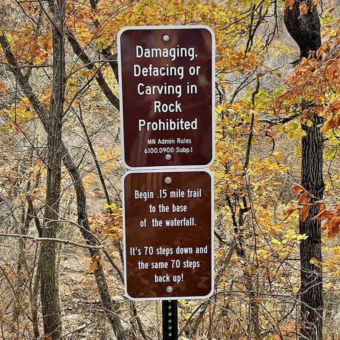 "70 steps down and 70 steps back up" – the sign promises a workout with a waterfall reward.