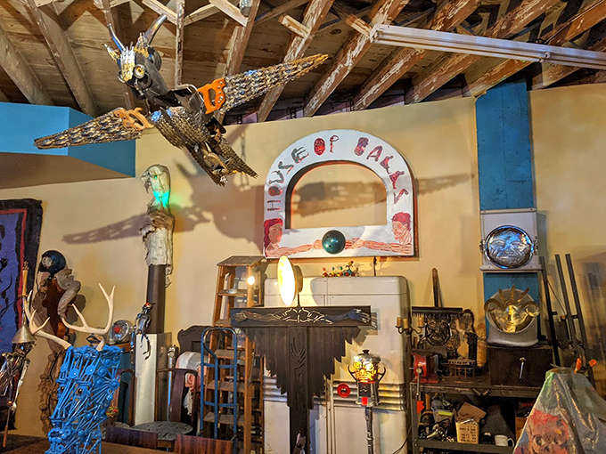 Suspended from weathered beams, this fantastical ship seems ready to sail through the imagination, crafted entirely from salvaged materials.