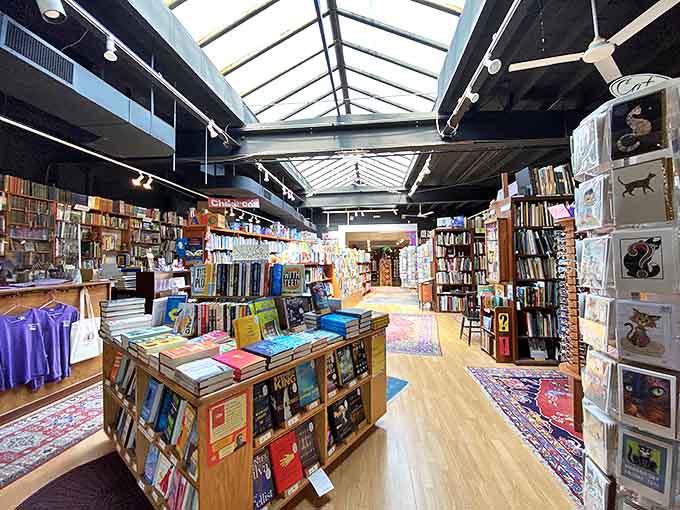 Natural light streams through the skylight onto carefully curated displays, creating a cathedral-like atmosphere where literature is clearly the religion.