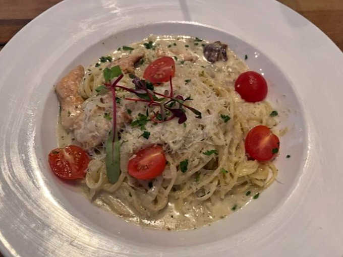 Linguine perfection: creamy pasta dotted with cherry tomatoes and fresh herbs &ndash; the kind of dish that makes you close your eyes with each bite.