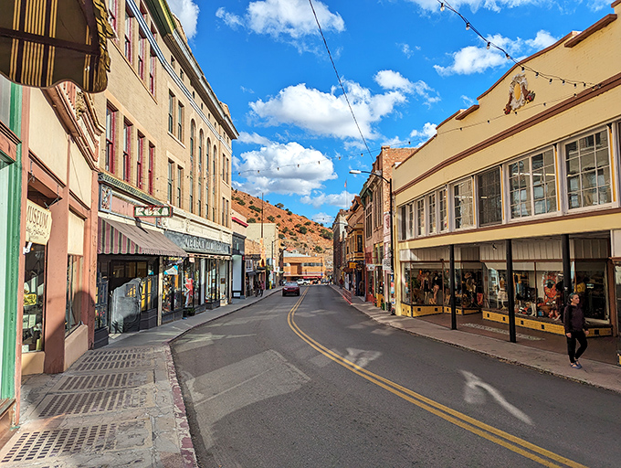 Bisbee's main street transforms at dusk, when string lights create a canopy of stars above historic buildings housing restaurants where miners once spent their hard-earned wages.