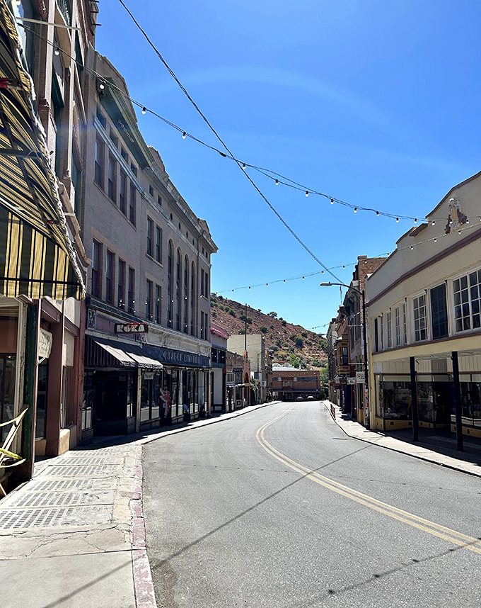 String lights crisscross above Bisbee's historic streets, creating a magical atmosphere when the desert sun finally sets.