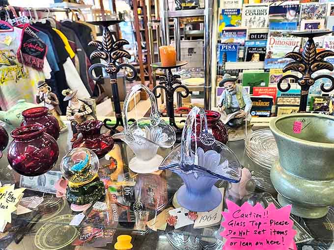 Red shelves bursting with vintage charm &ndash; where else can you find handcrafted dollhouses next to rustic farm tools and antique baskets?