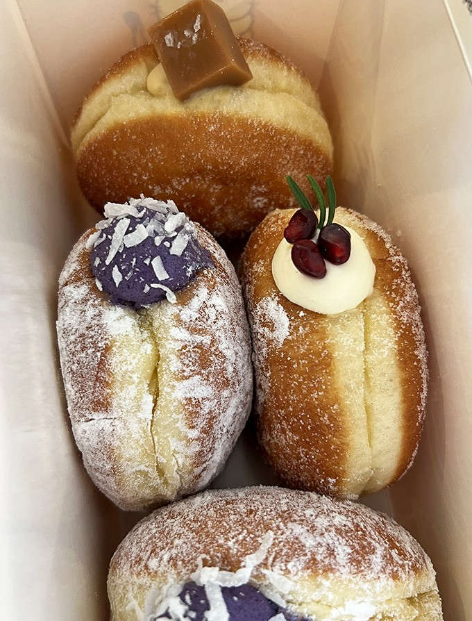 A box of assorted brioche donuts is basically a choose-your-own-adventure book, except every ending is delicious and involves cream.