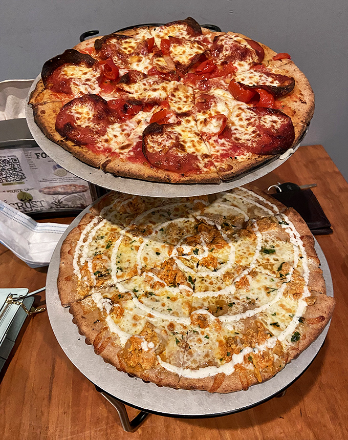 A wood-fired duo: classic pepperoni above, creamy buffalo chicken below, both baked to irresistible Folino&rsquo;s goodness.