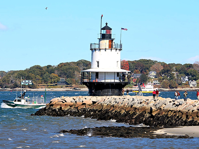 Visitors explore the granite breakwater, drawn like maritime pilgrims to this working piece of nautical history.