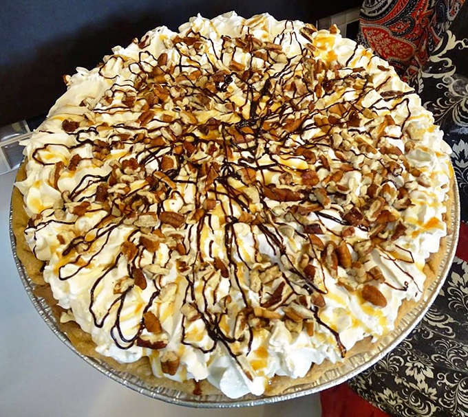 A caramel pecan masterpiece awaits lucky diners, its golden topping of nuts and caramel sauce promising a symphony of textures and flavors.