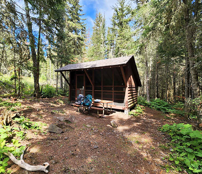 This rustic screened shelter offers wilderness luxury on Isle Royale – protection from elements and mosquitoes while keeping nature close.