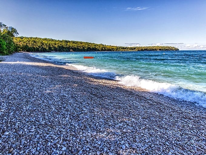Schoolhouse Beach Park's unique limestone shoreline gleams white against the clear waters, creating a natural wonder unlike any other beach.