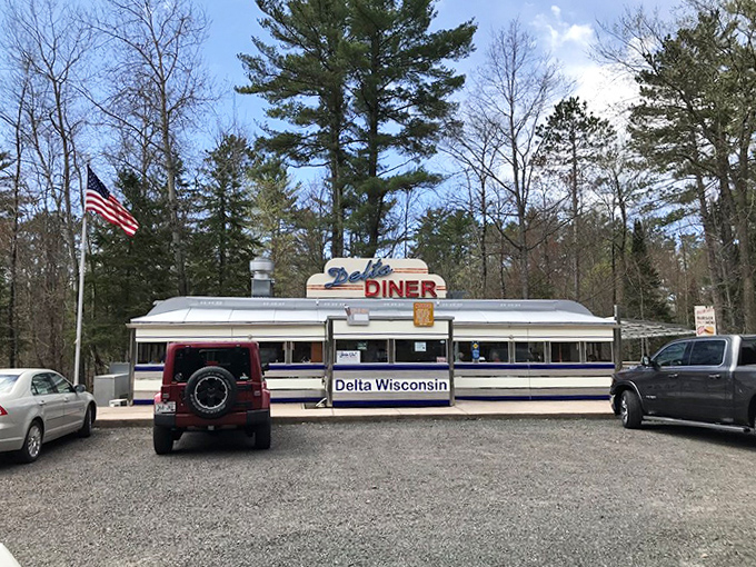 Delta Diner's vintage exterior stands proudly against the backdrop of towering pines, a shining beacon for breakfast lovers.