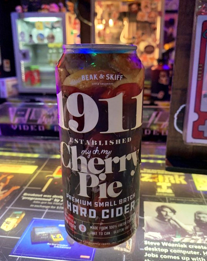 The 1911 Cherry Pie hard cider brings orchard freshness to your gaming session, its ruby tones matching the excitement of hitting a new high score.