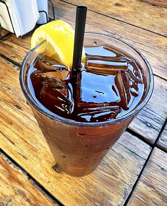 A tall glass of iced tea with lemon &ndash; the perfect companion to cut through the richness of a cheese-stuffed burger adventure.