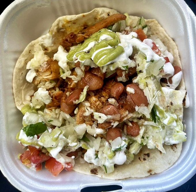 This adobo chicken taco is like a flavor piñata – crack it open and enjoy the explosion of perfectly seasoned meat, fresh toppings, and zippy sauce.