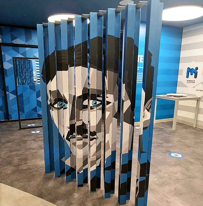 Art meets perception in this striking ambigram installation, where vertical slats reveal different images depending on your viewing angle.