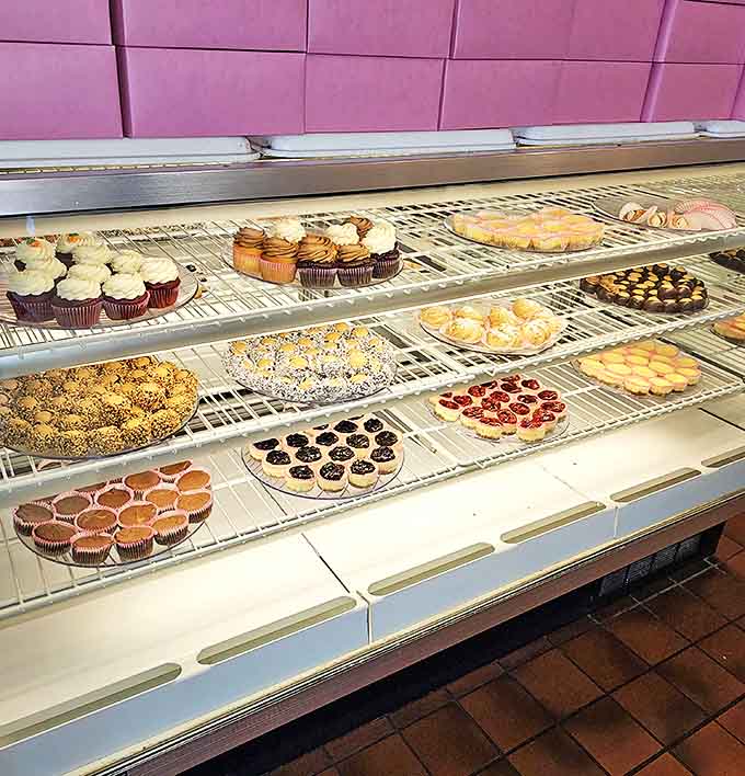The cupcake display showcases a rainbow of frosted perfection. Each one is a miniature celebration waiting to happen.