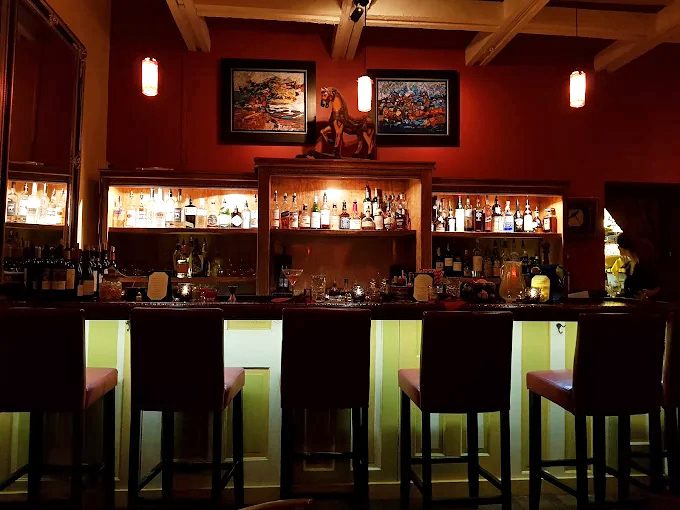 The bar doesn't just serve drinks&mdash;it crafts liquid stories. That horse statue is silently judging your cocktail choice.