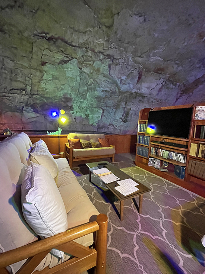 The Cavern Suite living room redefines "rock walls" with comfortable furnishings nestled against limestone formations millions of years in the making.
