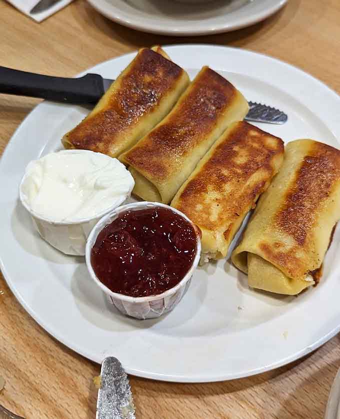 These blintzes are golden, cheese-filled perfection served with sour cream and jam, basically a hug in pancake form.