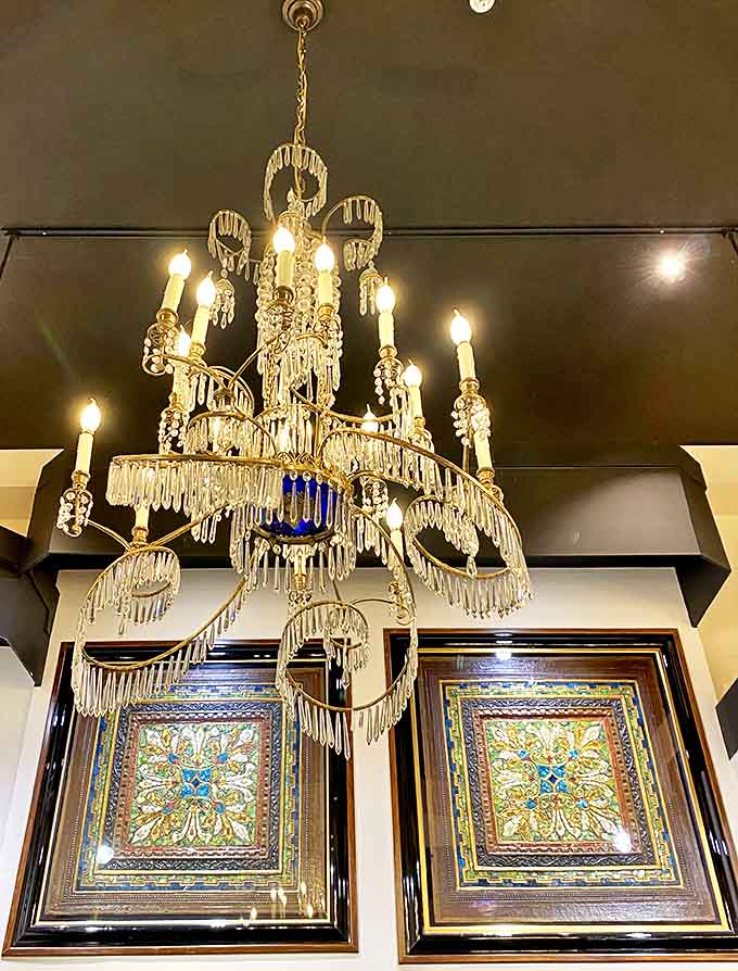 Crystal teardrops cascade from this magnificent chandelier, creating a frozen waterfall of light that transforms the space beneath into a dancing kaleidoscope.