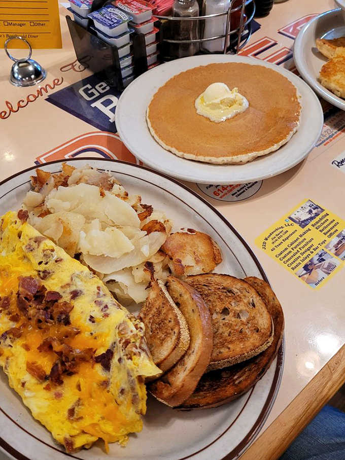 Breakfast harmony achieved: a cheese-laden omelet shares the spotlight with a solo hotcake, creating the breakfast equivalent of a perfect duet.
