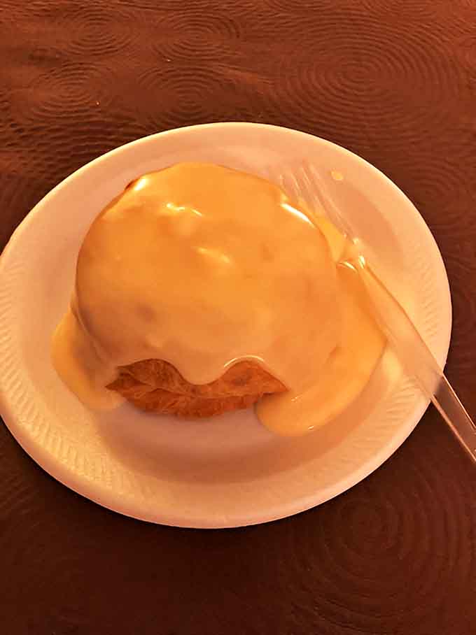 Comfort covered: A pasty smothered in savory gravy, transforming the hand-held meal into a fork-worthy feast of Upper Peninsula tradition.