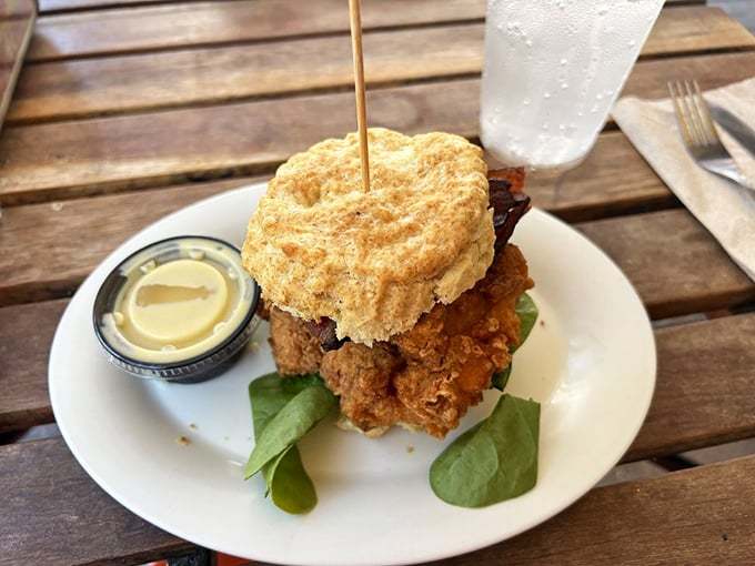 This towering chicken biscuit sandwich isn't just breakfast, it's an architectural marvel that somehow manages to be both rustic and refined.
