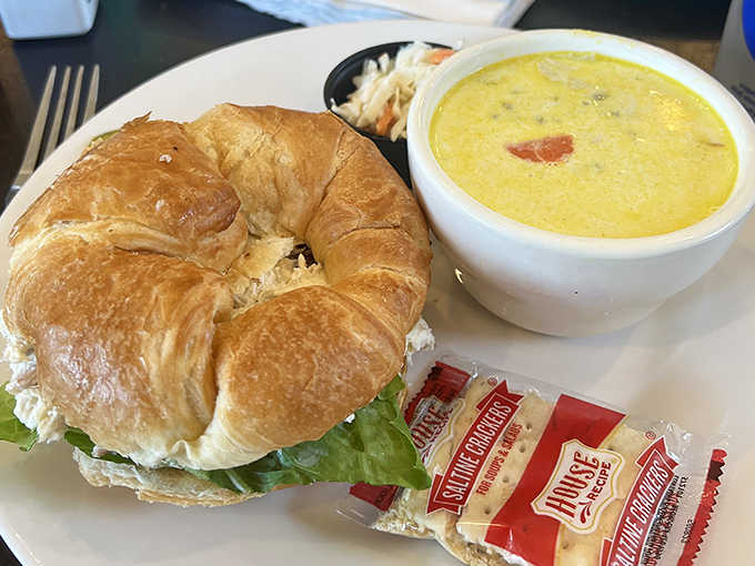 Lunch perfection: A golden croissant cradles chicken salad while creamy soup stands by, ready to warm Minnesota souls year-round.