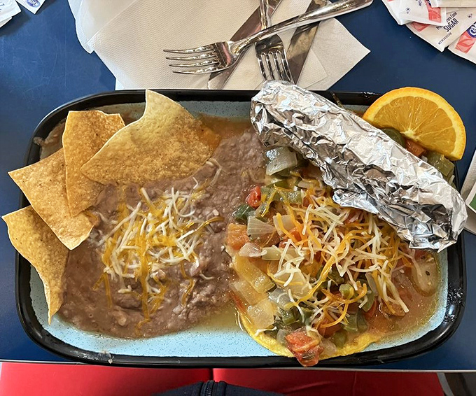 The chile relleno arrives like a gift &ndash; perfectly battered poblano pepper embracing melty cheese alongside rice and beans that demand respect.