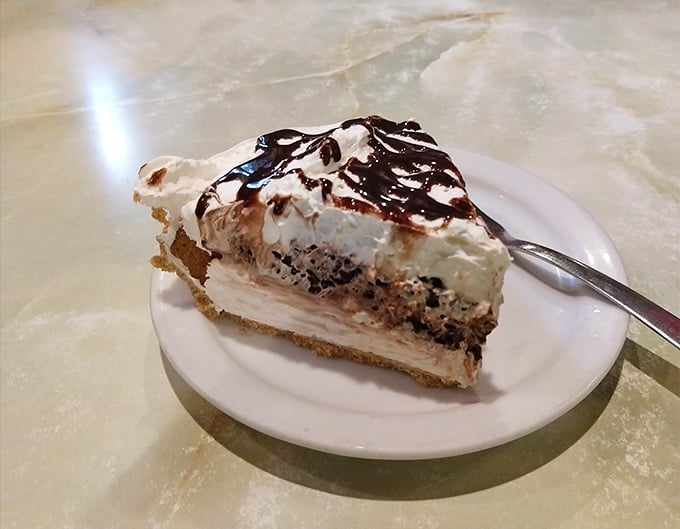 Layers of decadence stacked high with whipped cream crowning this slice of heaven &ndash; diet plans crumble at the mere sight.