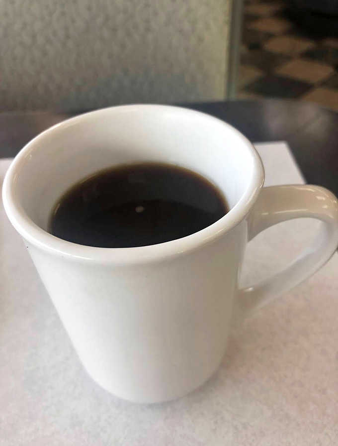 The lifeblood of diner culture, served hot and strong in an unpretentious mug that somehow makes every sip taste better.