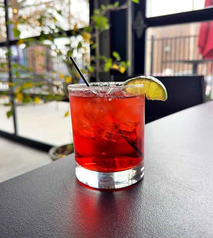 The Cranbarita glows ruby-red against its salt-rimmed glass, a tart and refreshing twist on the classic that's perfect for sipping on the patio.
