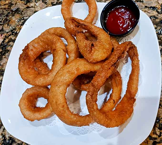 Beer-battered onion rings achieve that perfect balance of crispy exterior and tender interior that's harder to nail than it looks.