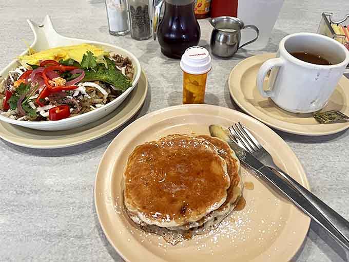 Morning rituals: steaming coffee, golden pancakes, and a hearty skillet – the breakfast of champions at Diner Grill.