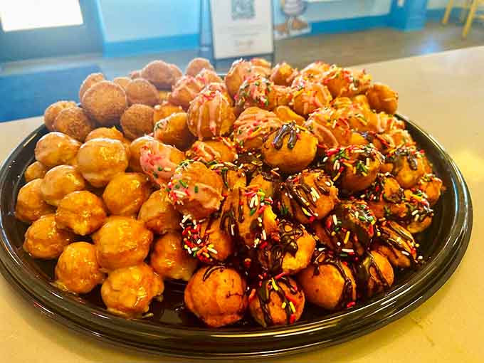 Mini donuts piled high like edible treasure, each bite-sized piece packed with maximum flavor potential.
