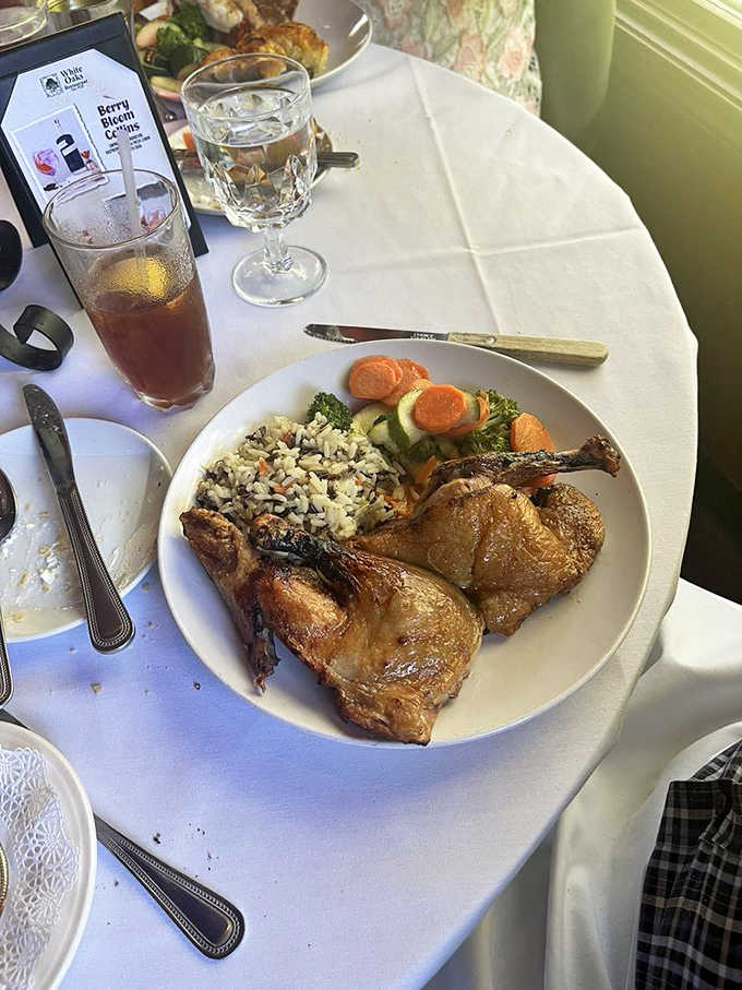 Golden-skinned duck rests beside a colorful rice pilaf, demonstrating that poultry, when properly prepared, can hold its own against any beef contender on the menu.