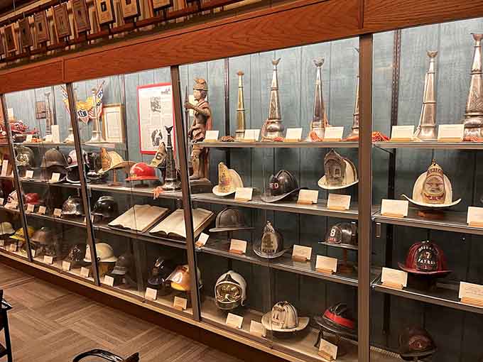 The collection of vintage firefighter helmets showcases evolving safety standards and the distinctive styles that different departments adopted over the decades.