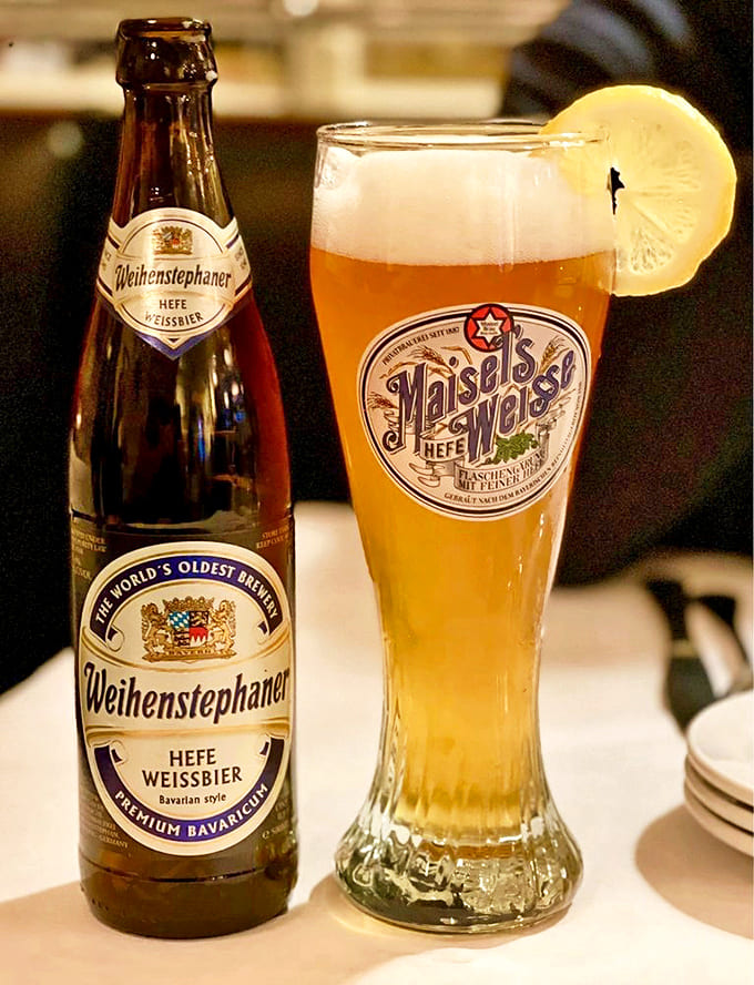 Germany's liquid gold pours perfectly into a traditional weizen glass, its cloudy amber depths promising refreshment with centuries of brewing tradition.
