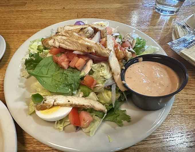 Fresh salad with grilled chicken offers a lighter option for those rare moments when you're not craving carbs and cheese.