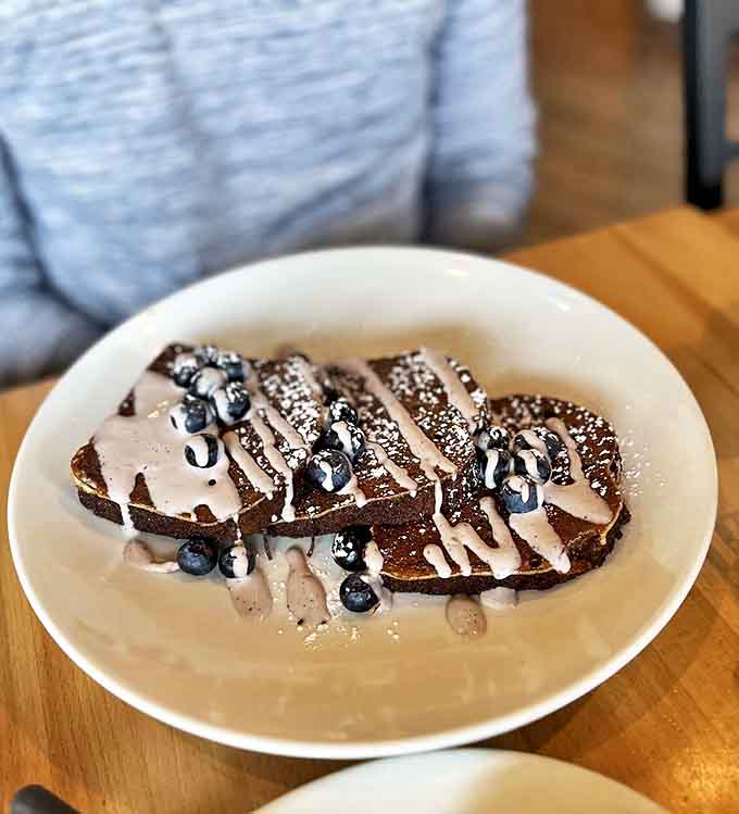 Banana bread French toast drizzled with chocolate sauce is basically dessert masquerading as breakfast, and nobody's complaining about the deception.