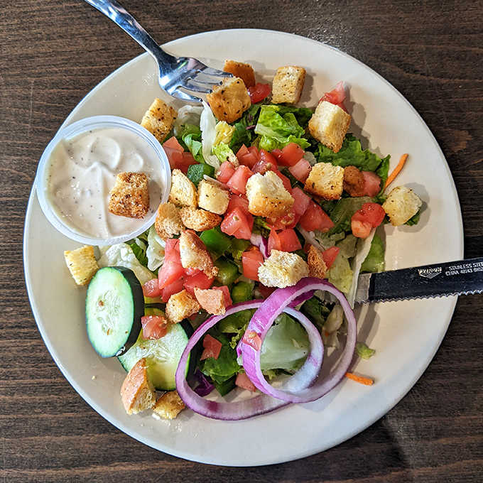 Fresh salads provide a crisp counterpoint to pizza indulgence &ndash; this house salad with its colorful vegetables isn't an afterthought.