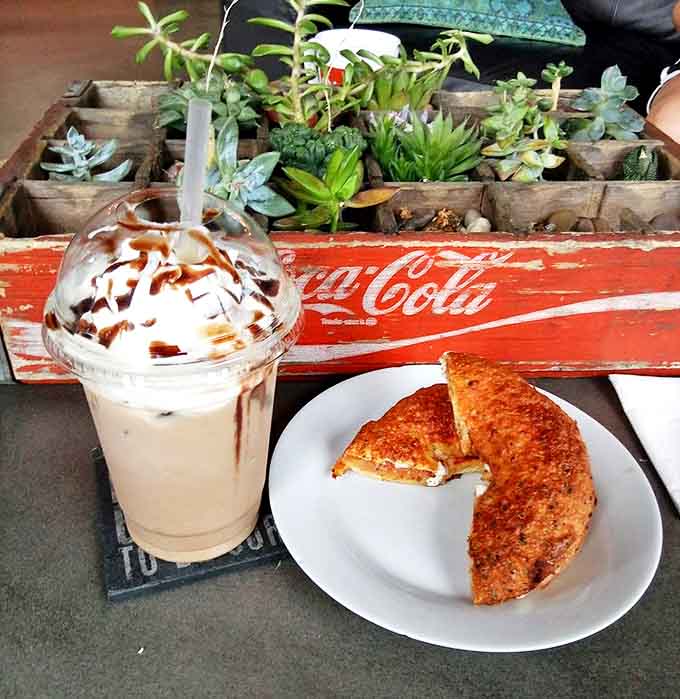 The perfect lunch combo: a golden-brown panini with melty cheese alongside an iced mocha that's basically dessert in disguise.