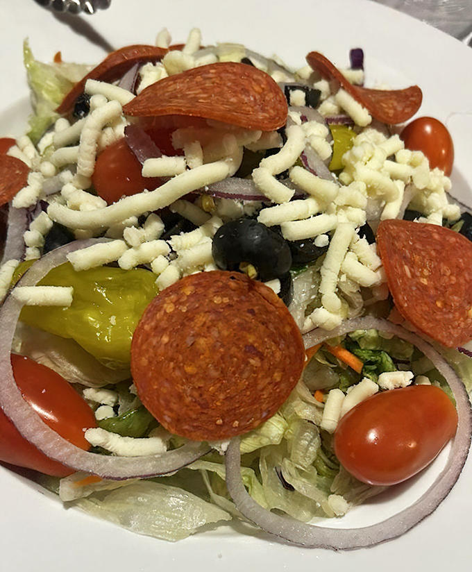 The Italian salad &ndash; a colorful arrangement of crisp vegetables and pepperoni &ndash; offers a refreshing counterpoint to pizza indulgence.