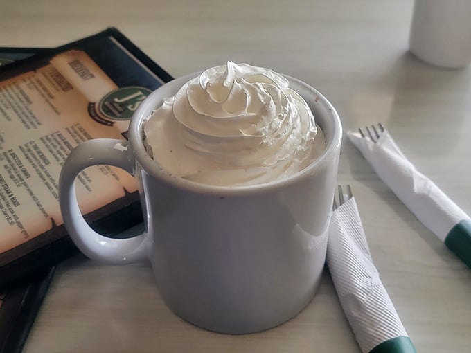 Hot chocolate topped with whipped cream that towers like a delicious snow drift, because even the beverages here understand that more is more.